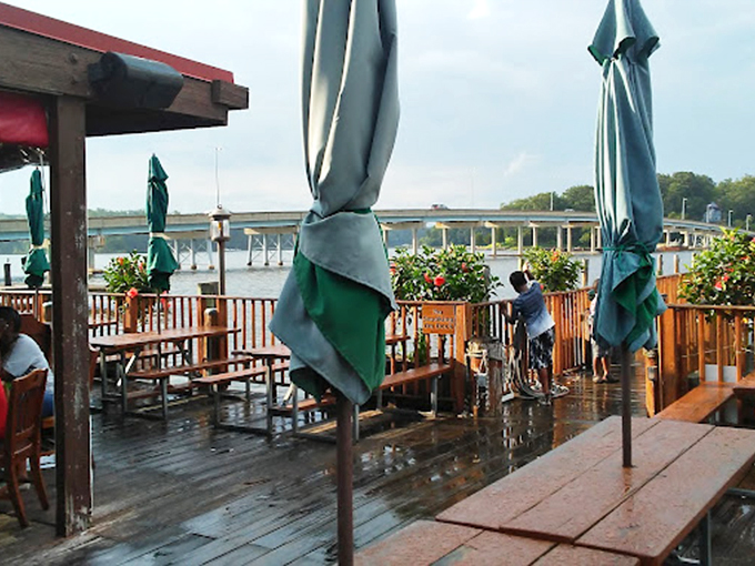 After a summer shower, the deck glistens with promise—empty tables patiently waiting for the next round of seafood enthusiasts.