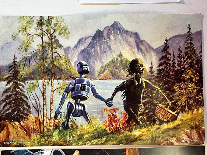Robot meets gas-masked human for a pastoral picnic. This twisted take on classic landscape art redefines "strange bedfellows."