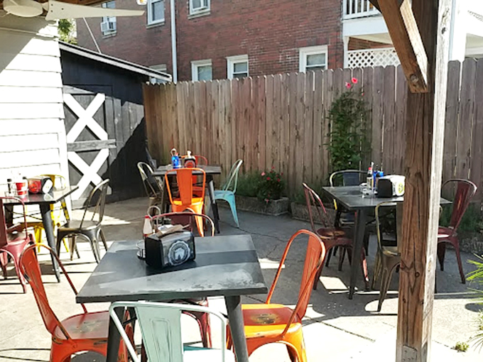 The patio's colorful chairs aren't just seating&mdash;they're front-row tickets to an al fresco feast where Kentucky sunshine meets Nashville heat in perfect harmony.