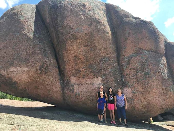 Humans for scale! These massive granite formations dwarf visitors, offering perspective on our tiny place in Earth's grand timeline.