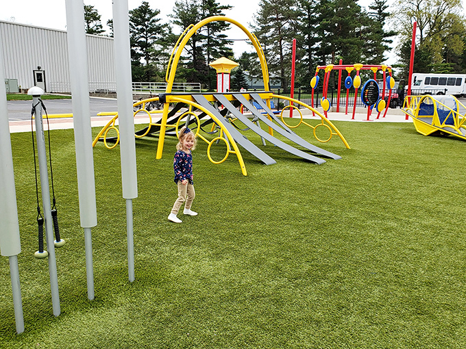 Modern playground equipment creates an explosion of primary colors against the green landscape&mdash;like a children's book illustration sprung gloriously to life.