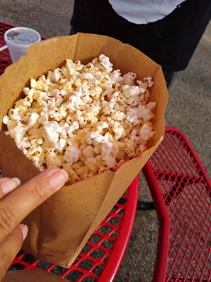 Popcorn in a paper cone&mdash;proof that sometimes the simplest pleasures require nothing more than butter and nostalgia.