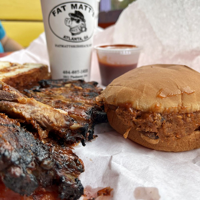 This pulled pork sandwich isn't just a meal, it's a structural engineering marvel holding tender, smoky meat between two humble bread slices.