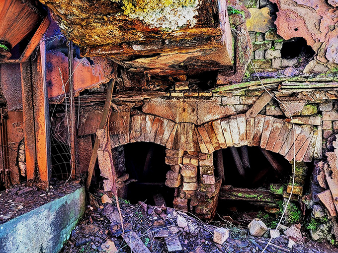 Sloss Furnaces reflects itself in rainwater puddles, creating a double vision of Birmingham's industrial past that's twice as haunting. 