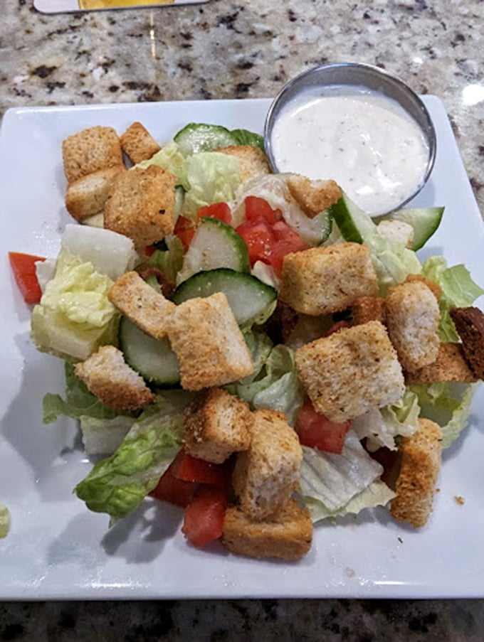 A house salad that doesn't apologize for being exactly what it is&mdash;fresh, crisp, and the perfect companion to whatever meat-centric main you've ordered. 