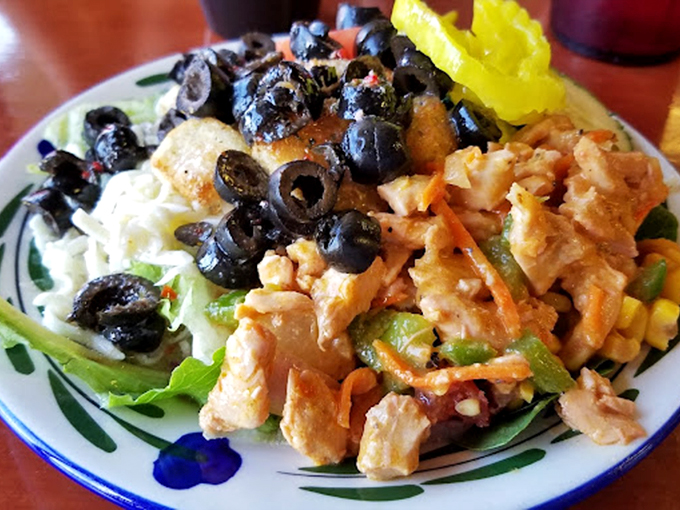 A salad that doesn't apologize for being a salad. Those black olives and that buffalo chicken are staging a flavor intervention for boring lunch options everywhere.