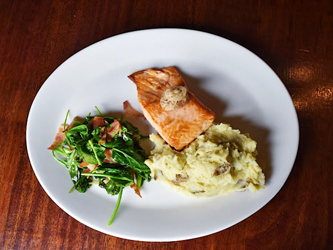 The bar's ornate woodwork and "Sl&aacute;inte" sign invite you to settle in for stories, pints, and the kind of evening that becomes a cherished memory. 