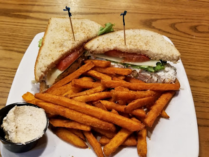 This isn't just a sandwich&mdash;it's architecture. Layers of goodness secured by toothpick skyscrapers, with sweet potato fries standing guard.