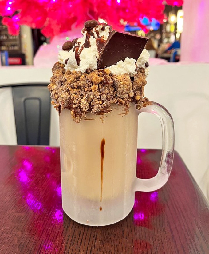 This isn't just a milkshake, it's a structural engineering marvel topped with enough goodies to qualify as its own food group.