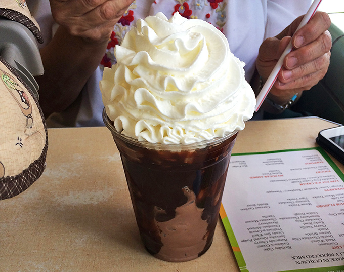 This isn't just a chocolate shake&mdash;it's a mountain of whipped cream with a chocolate lake beneath. Straws are merely suggested tools.