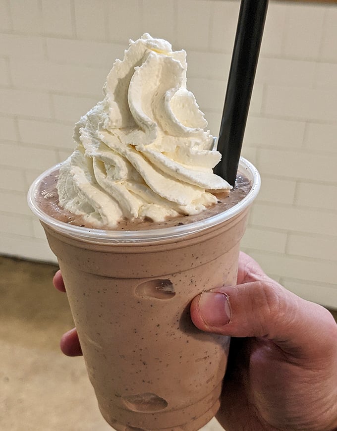 This isn't just a milkshake—it's a drinkable masterpiece topped with whipped cream that defies both gravity and restraint.