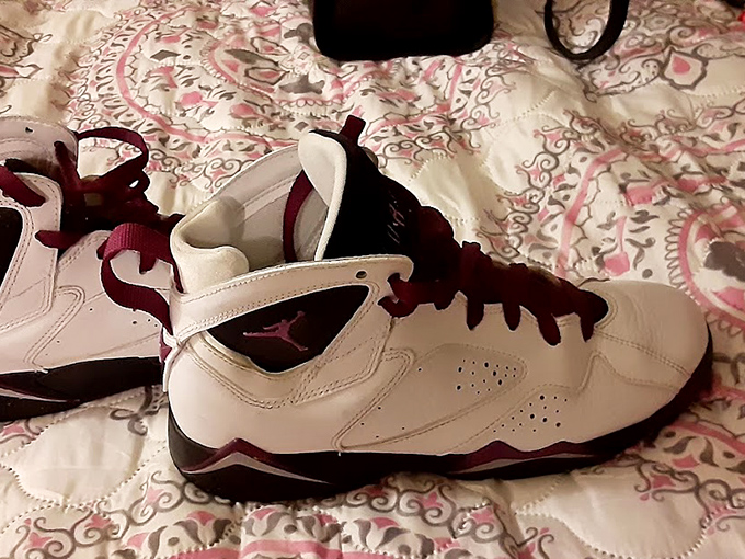 Vintage Jordans resting on a patterned bedspread &ndash; sneakerheads know thrifting is where the real limited-edition treasures hide.