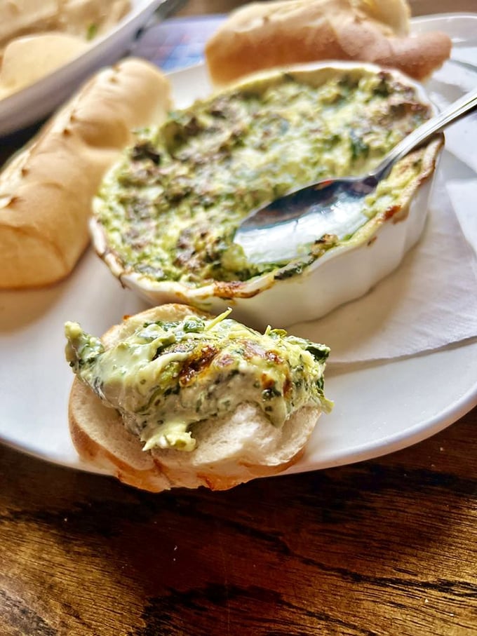 The spinach and artichoke dip arrives bubbling like a Celtic hot spring, ready to transform ordinary bread into vehicles of extraordinary flavor.
