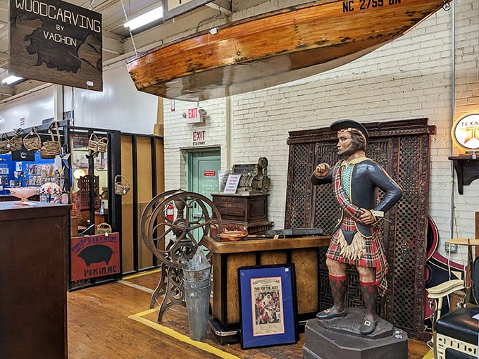 Not your average lawn ornament! This life-sized figure stands guard over an eclectic collection of maritime and historical artifacts.