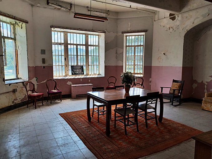 Elegant arched hallways with warm lighting belie the building's darker purpose. The architectural beauty of the asylum reminds us that intentions were initially humanitarian.