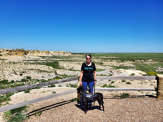 Who needs a beach vacation? This visitor and her four-legged companion discover that Kansas badlands offer views rivaling any coastal overlook.