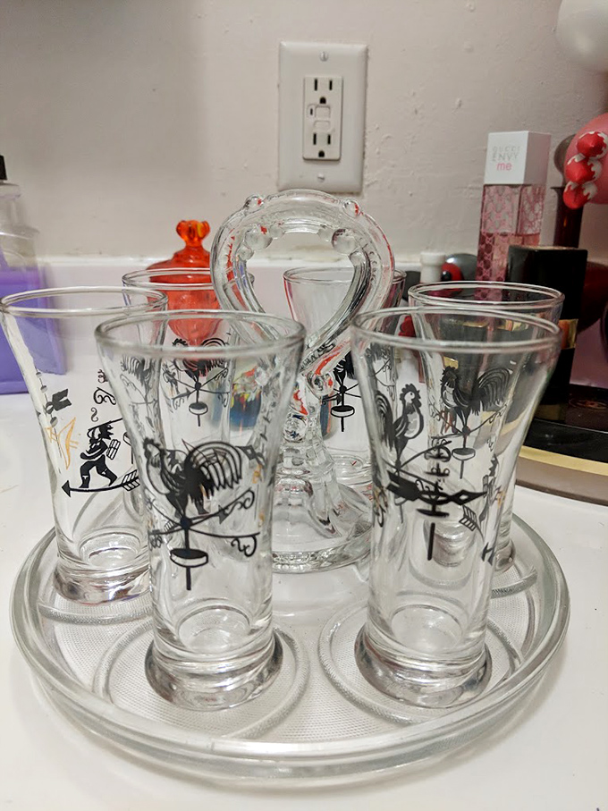A collection of vintage glasses with whimsical rooster designs &ndash; because even your barware deserves a backstory and a touch of personality.