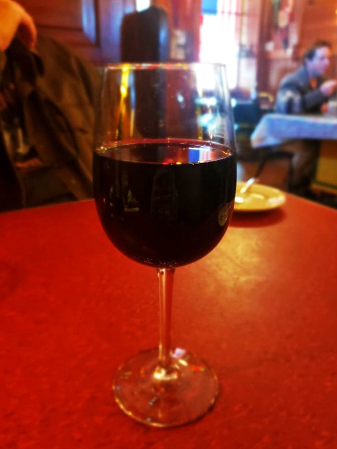 Relax and unwind as you sip a glass of rich red wine in this cozy, welcoming tavern atmosphere with friends.