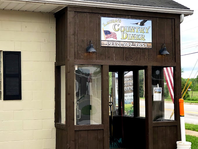 Laura's Country Diner: The rustic wooden entrance and American flag welcome you to a slice of heartland dining where farm-to-table isn't trendy &ndash; it's tradition.