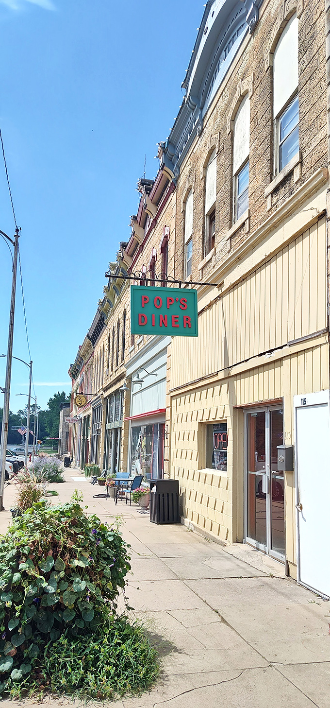 Pop's Diner: That cheerful green sign hanging from a historic building promises comfort food with a side of small-town charm.