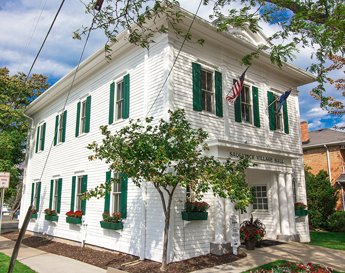 Saugatuck Village Hall stands crisp and white against blue skies, housing small-town governance with New England charm.