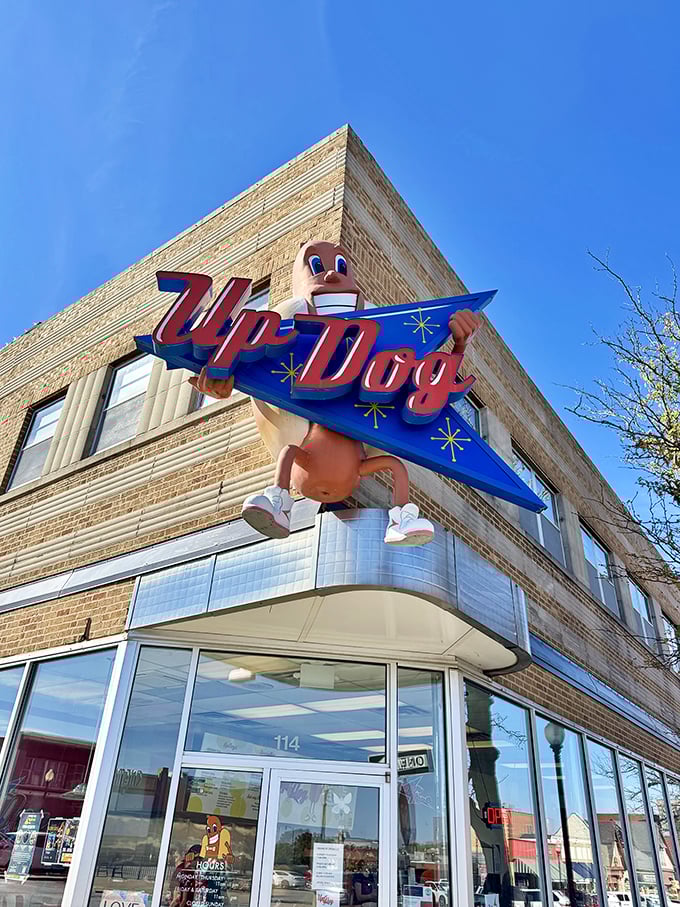 Up Dog's vintage-inspired corner sign and cartoon mascot bring a playful touch to downtown Independence's food scene.