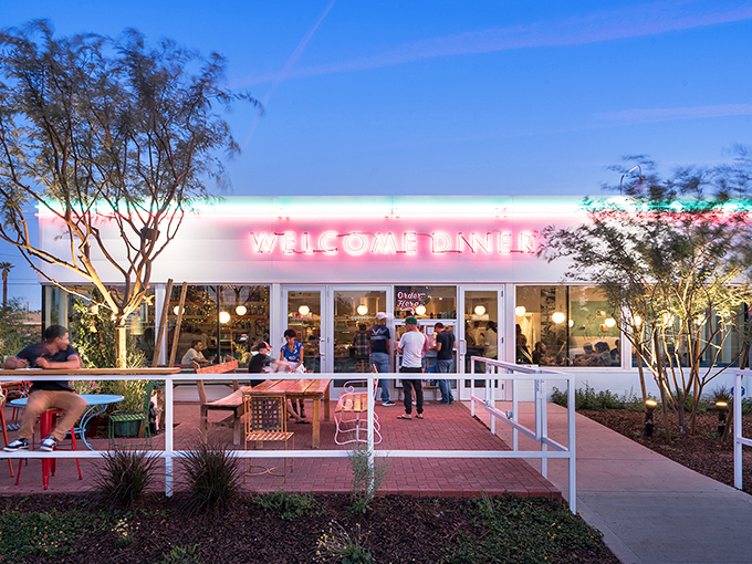 The neon glow of Welcome Diner isn't just inviting&mdash;it's practically a hug in light form. Their patio feels like the coolest backyard party in town.