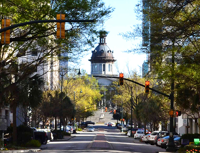 Tree-lined streets lead to Columbia's capitol building, where retirement dollars stretch further than political promises.