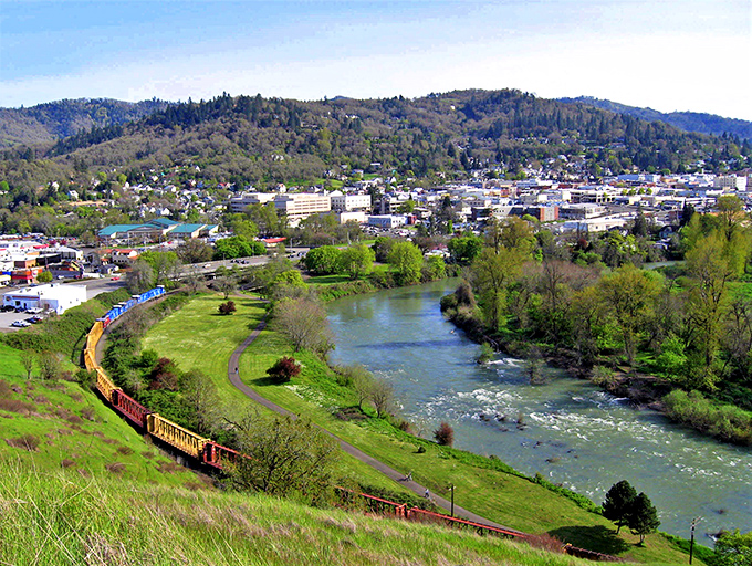 Aerial view of Roseburg with the Umpqua River winding through town &ndash; where your retirement dollars flow just as smoothly.