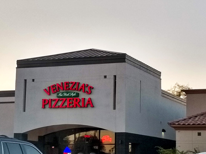 Nothing says "serious pizza business" like a name that glows red against the twilight sky.