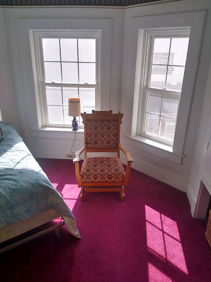 Sunlight streams through the windows onto this antique chair, creating shadows that seem to move when you're not looking directly at them.