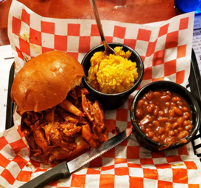 The pulled pork sandwich: where shredded smoky goodness finds its perfect home between bread, with sides that refuse to be mere afterthoughts.