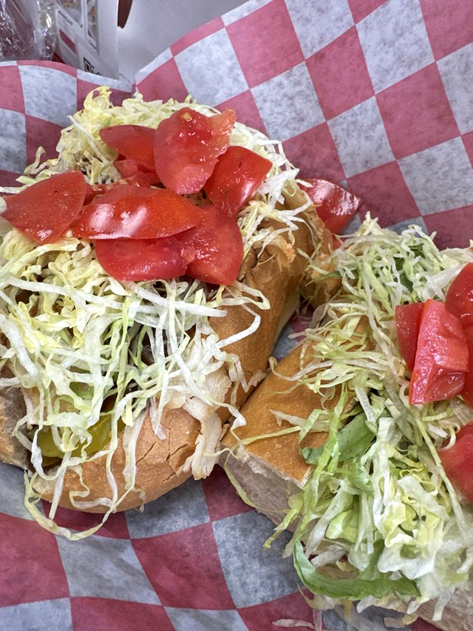 Shredded lettuce cascading over a sub like confetti at a sandwich celebration. Fresh tomatoes add pops of color that promise flavor.