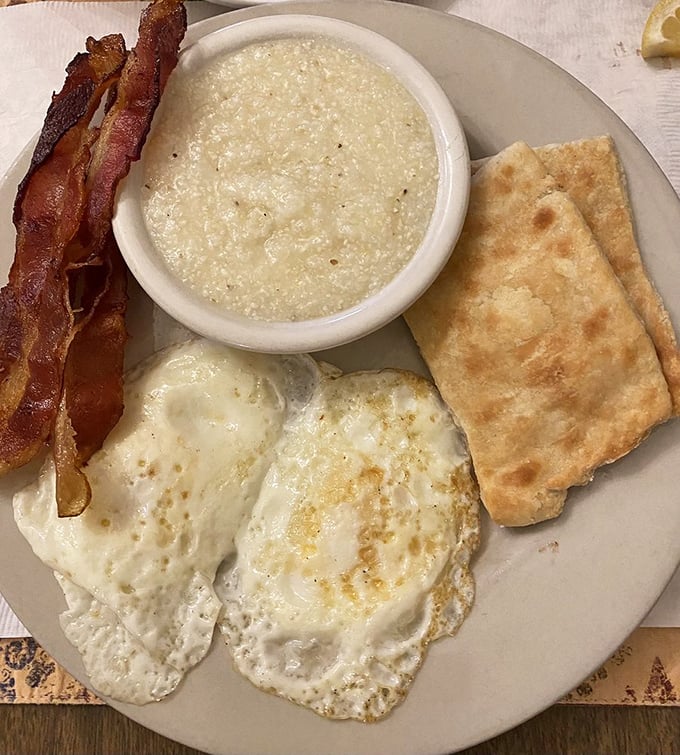Southern breakfast perfection! Creamy grits, crispy bacon, and sunny-side eggs bring the kind of morning joy that coffee alone can't provide.