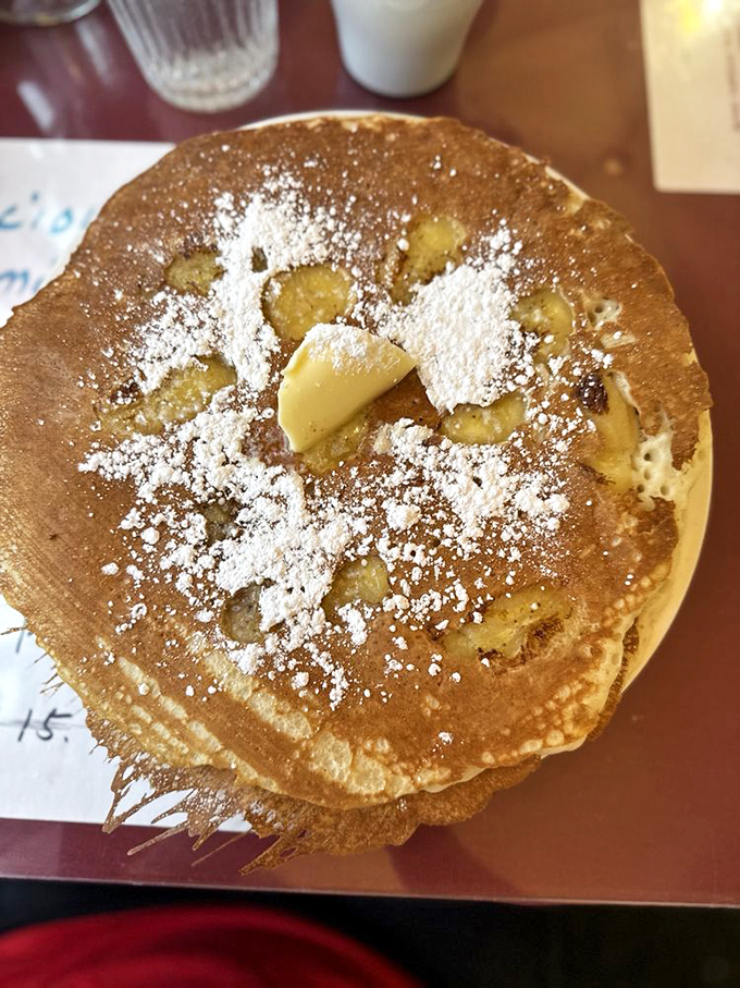 Breakfast with attitude: crispy bacon, sunny-side-up egg, and home fries that look like they've been practicing their flavor game for decades. 