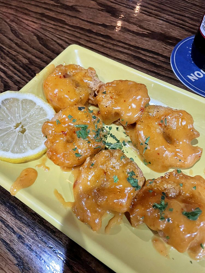 These Bang Bang Shrimp, glistening with spicy sauce and garnished with herbs, are what would happen if the ocean and a spice cabinet had a beautiful baby.