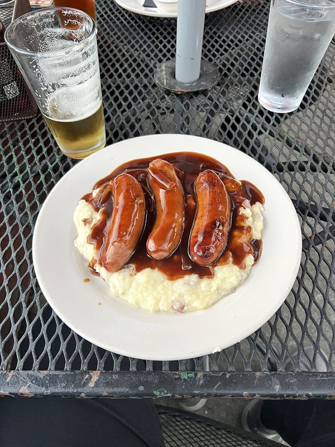 Bangers and mash: where plump, juicy sausages lounge on creamy mashed potatoes, all swimming in rich onion gravy. British comfort in its purest form.