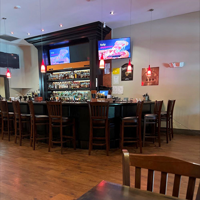 The bar area: where bourbon dreams and burger fantasies converge under the warm glow of pendant lighting.
