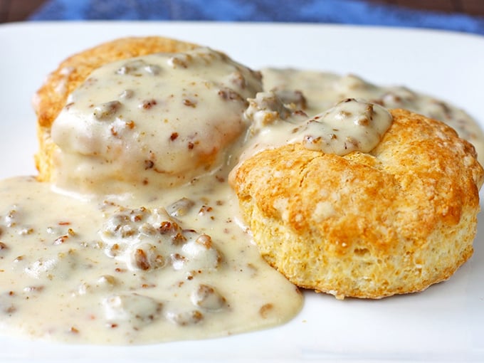 These aren't just biscuits and gravy &ndash; they're edible clouds swimming in savory heaven, the kind of breakfast that makes you rethink your morning routine.