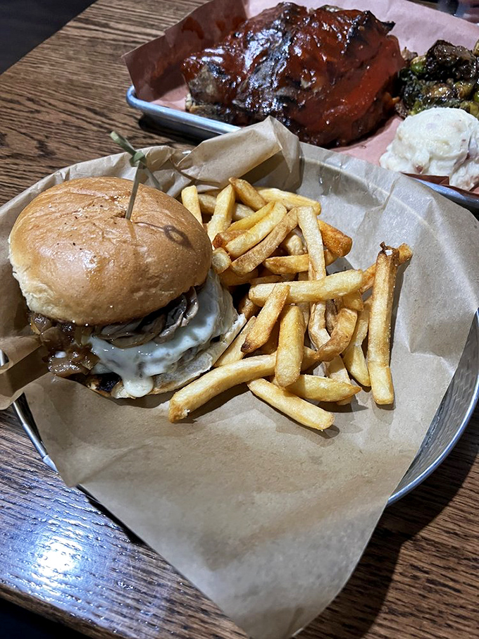 A burger and fries served on brown paper&mdash;because when the food is this good, fancy plates would just be showing off.
