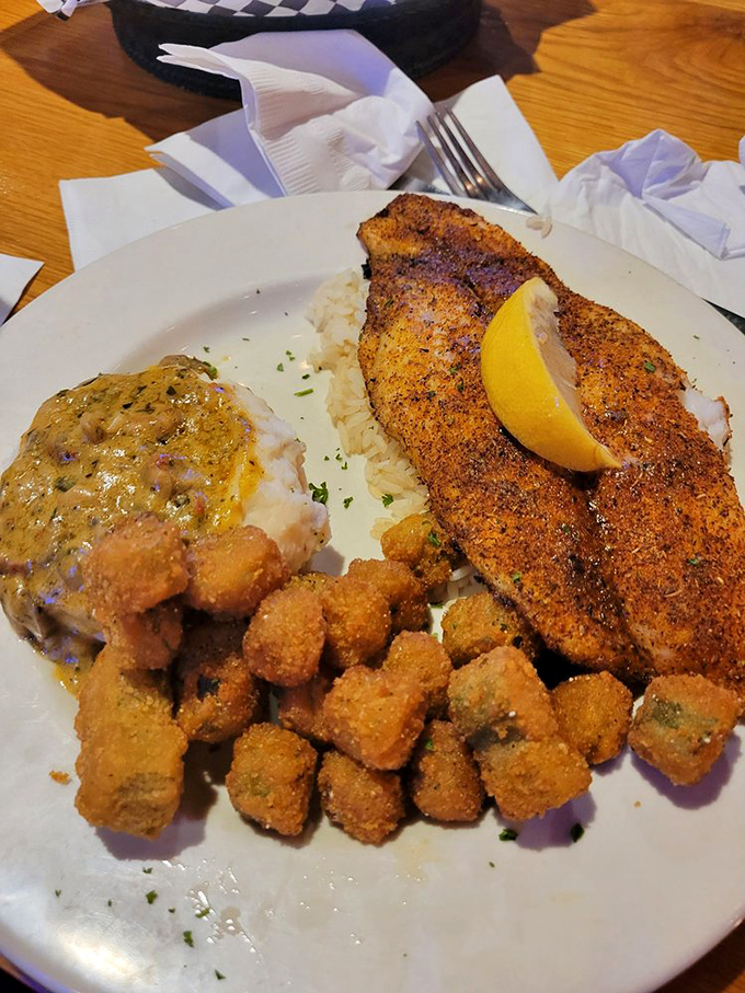 Cajun catfish that's dressed to impress with a golden crust and rice pillow. Those fried okra bites are the backup singers this plate deserves.