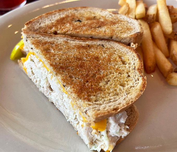 Grilled bread hugging melted cheese and chicken salad in a warm embrace that says, "Diet plans? We don't know her."