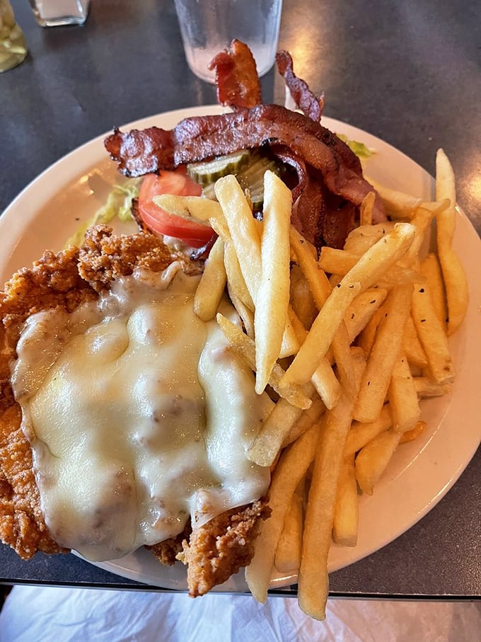 Fried chicken perfection meets melted cheese with crispy fries standing guard. Some meals don't need fancy descriptions&mdash;they just need to be eaten.
