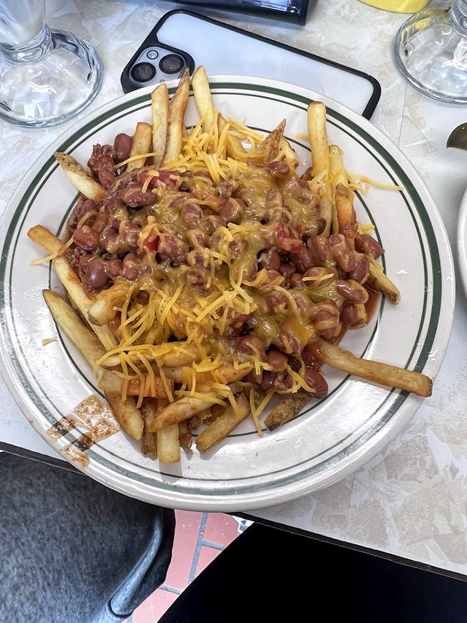French fries living their best life under a molten lava flow of chili and cheese. Diet plans surrender at the door.