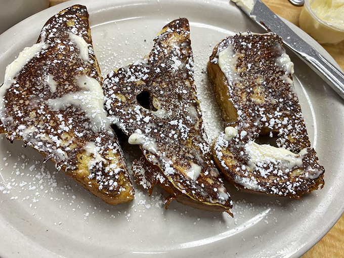 French toast that makes regular toast feel inadequate. Dusted with powdered sugar like a winter wonderland you can actually enjoy eating.