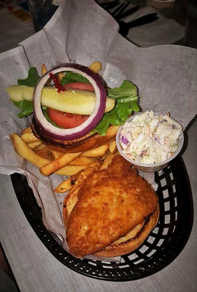 A sandwich that demands to be noticed. The golden-fried fish peeks out from its bun like it's ready for its close-up on a food magazine cover.