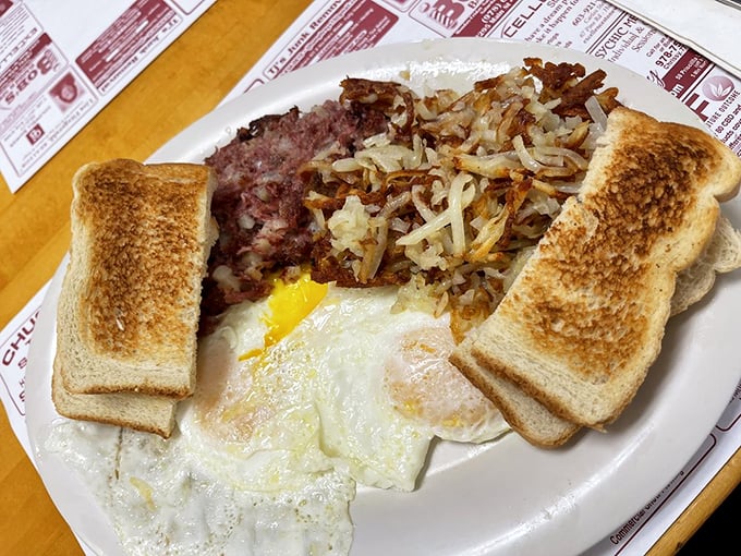 The holy trinity of breakfast: perfectly cooked eggs, crispy hash, and golden toast &ndash; a plate that says "good morning" better than words ever could. 