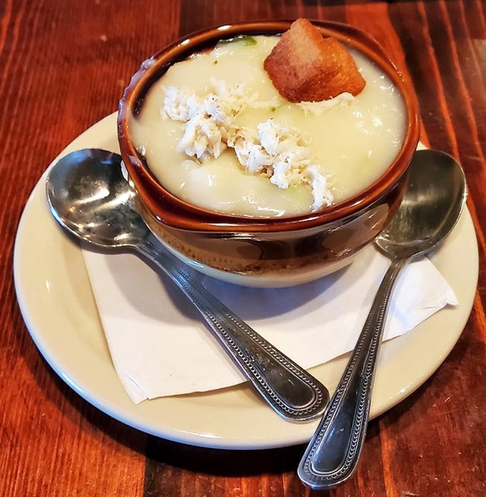 This crab bisque isn't just soup; it's a creamy ocean hug in a bowl, topped with a perfect crown of crab meat and a hint of sherry.