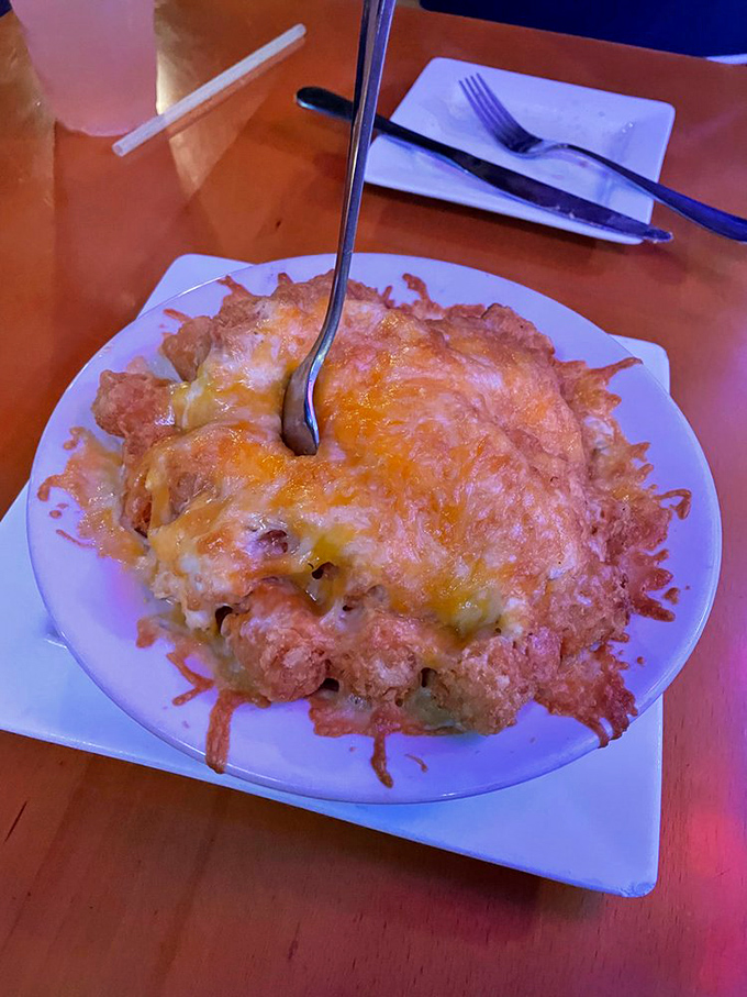 Whatever culinary genius first thought of combining tater tots with cheese and crab deserves a monument taller than Delaware's highest point.