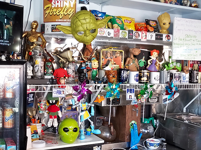 A Yoda head watches approvingly as Chewbacca, E.T., and other cosmic celebrities stand guard over the coffee station and kitchen pass.